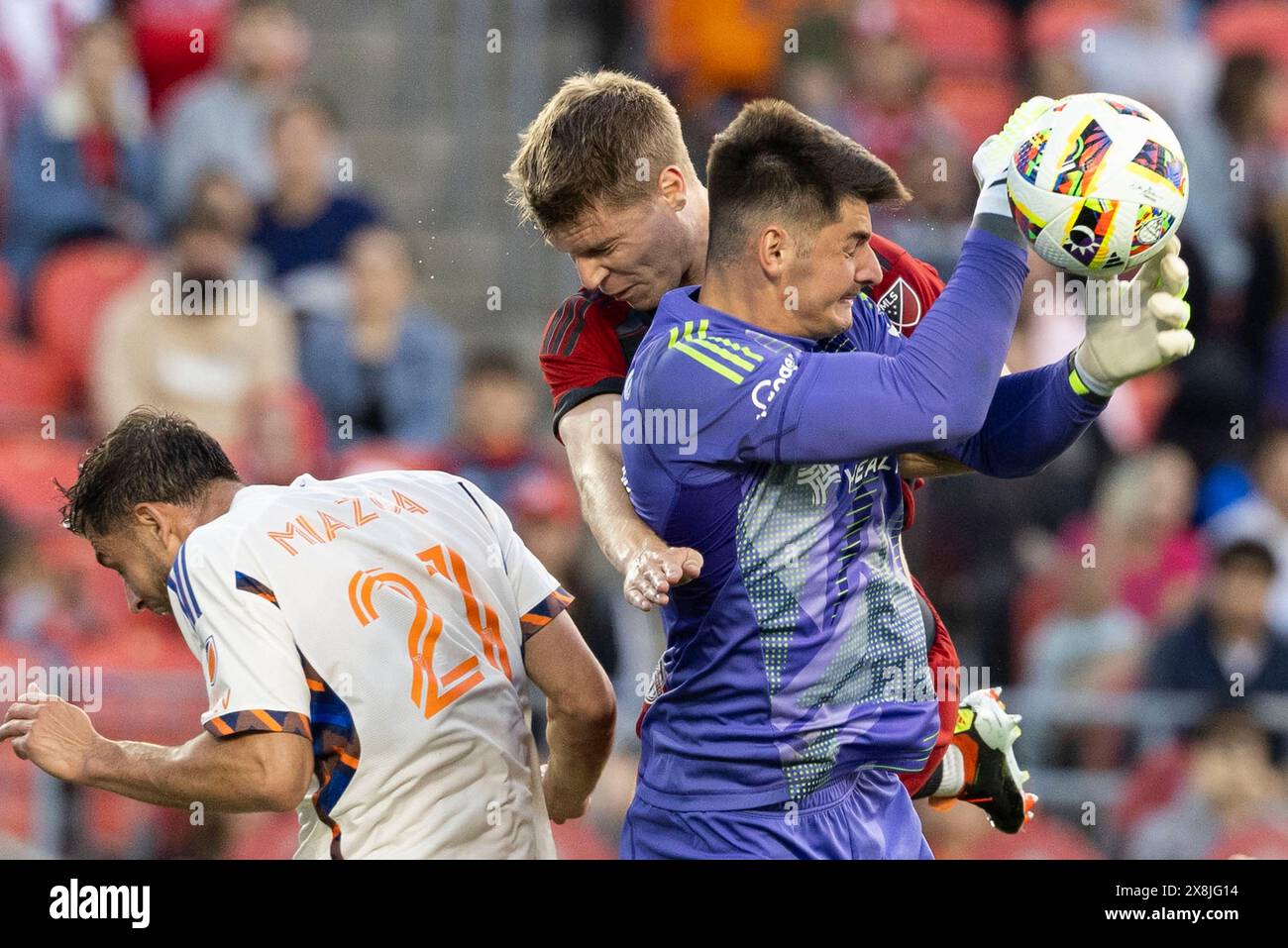 Toronto, Canada. 25th May, 2024. Sigurd Rosted (C) of Toronto FC vies ...