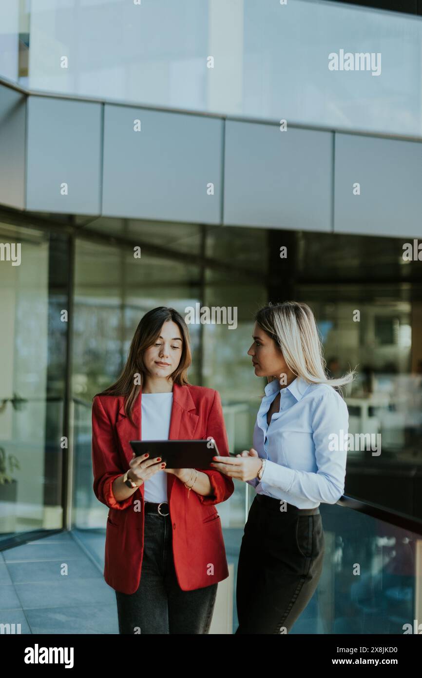 Two professional women engage in a thoughtful discussion while ...
