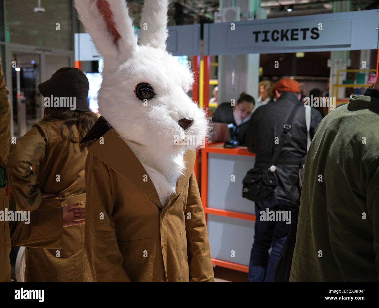 Manchester UK. Person in large white rabbit costume waiting in line at ...