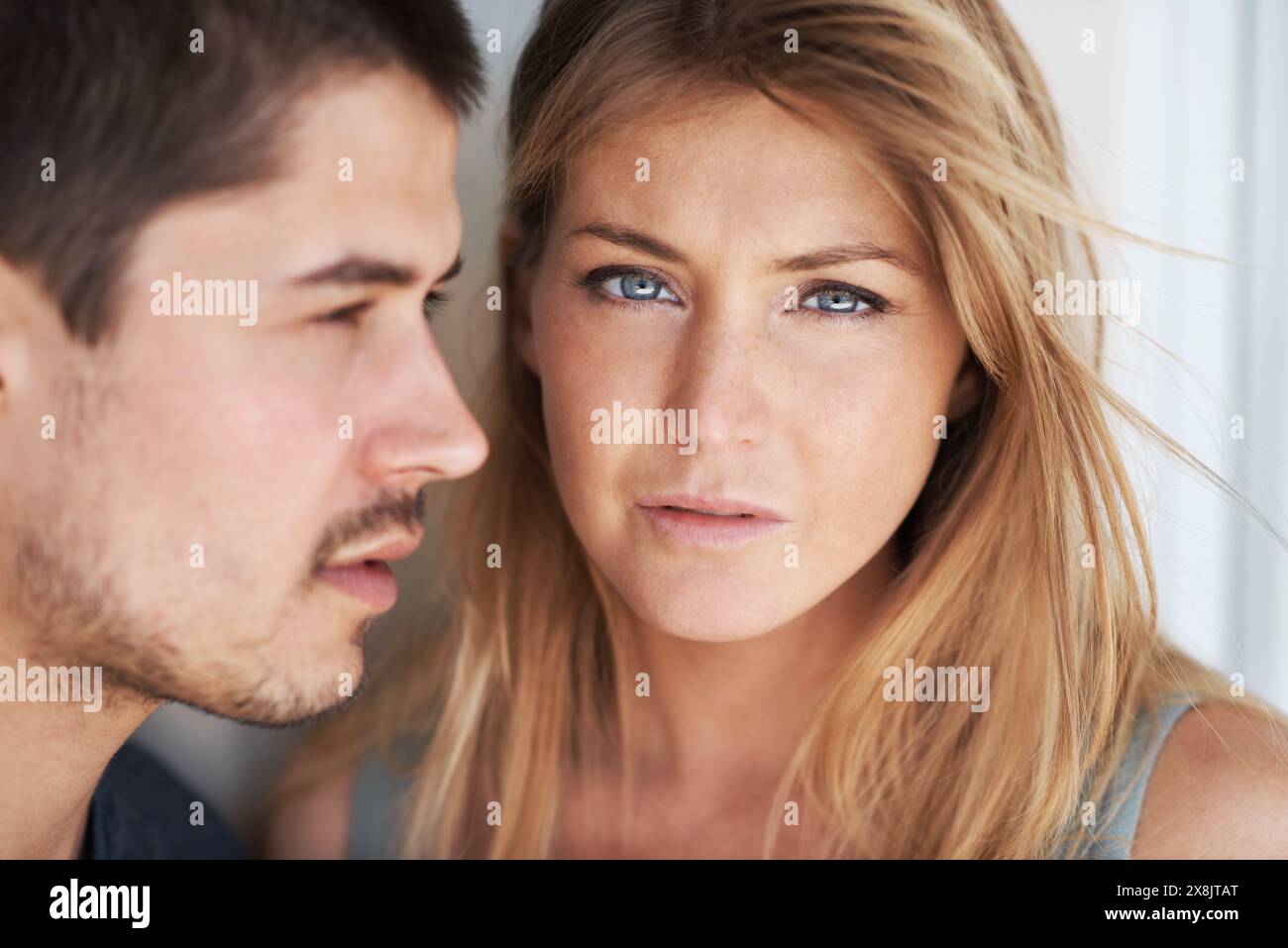 Man, woman and portrait in home by wall with thinking, serious and ...