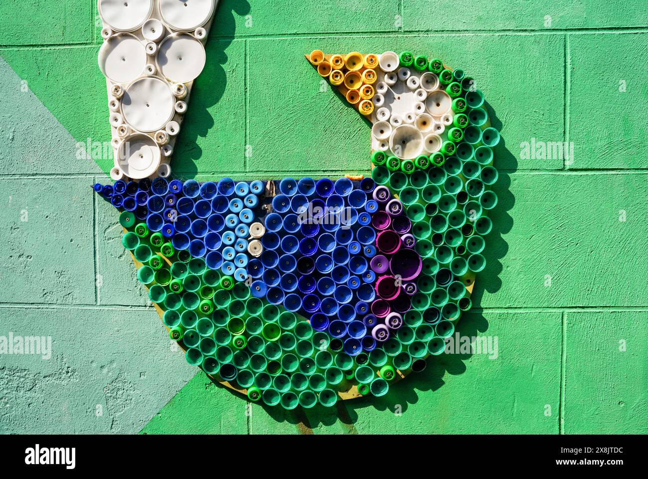 Colourful artwork created out of plastic bottle caps attached to ...