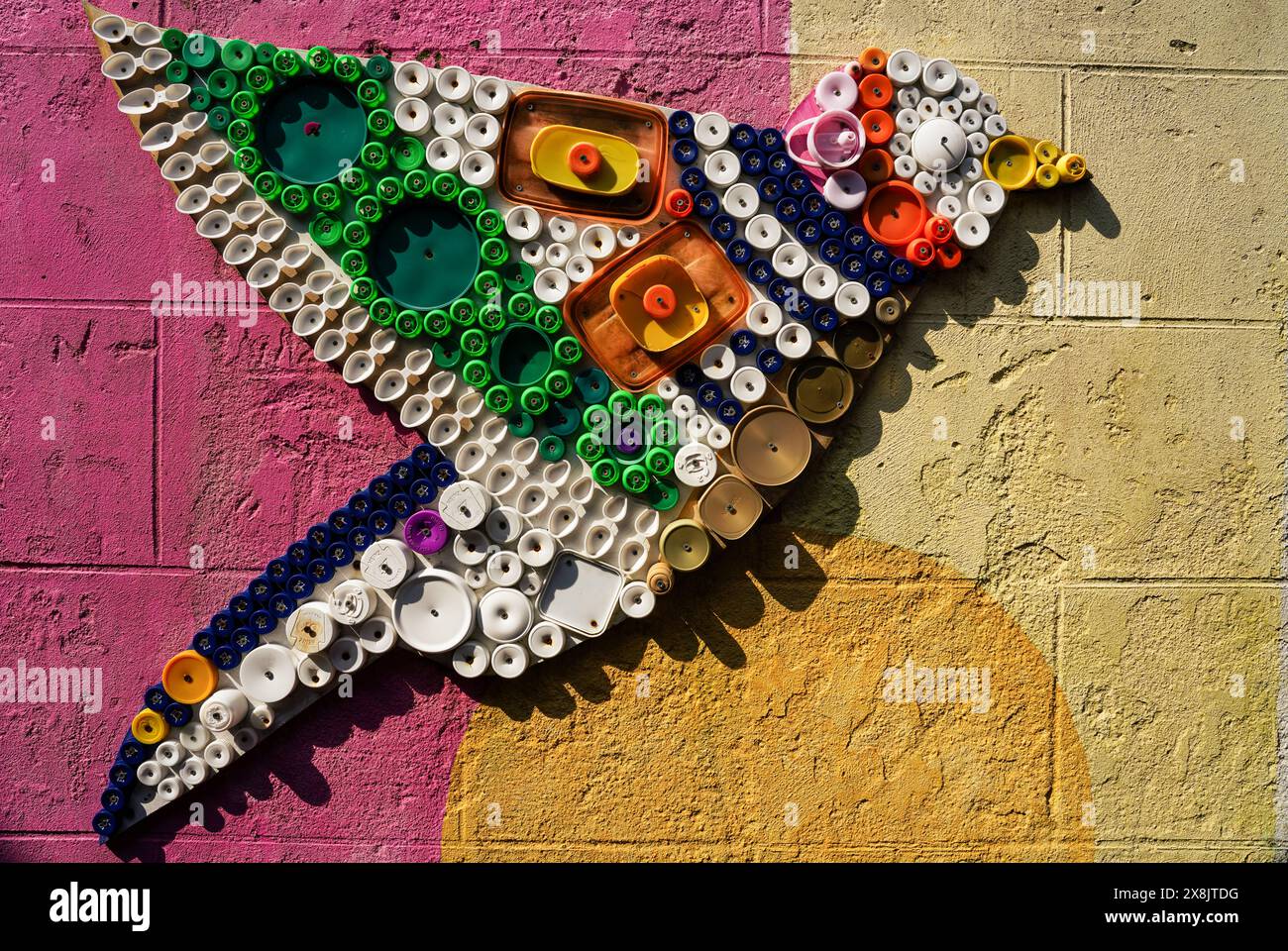 Colourful artwork created out of plastic bottle caps attached to ...