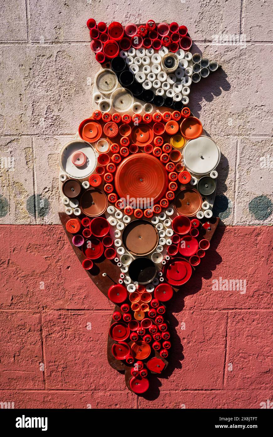 Colourful artwork created out of plastic bottle caps attached to ...