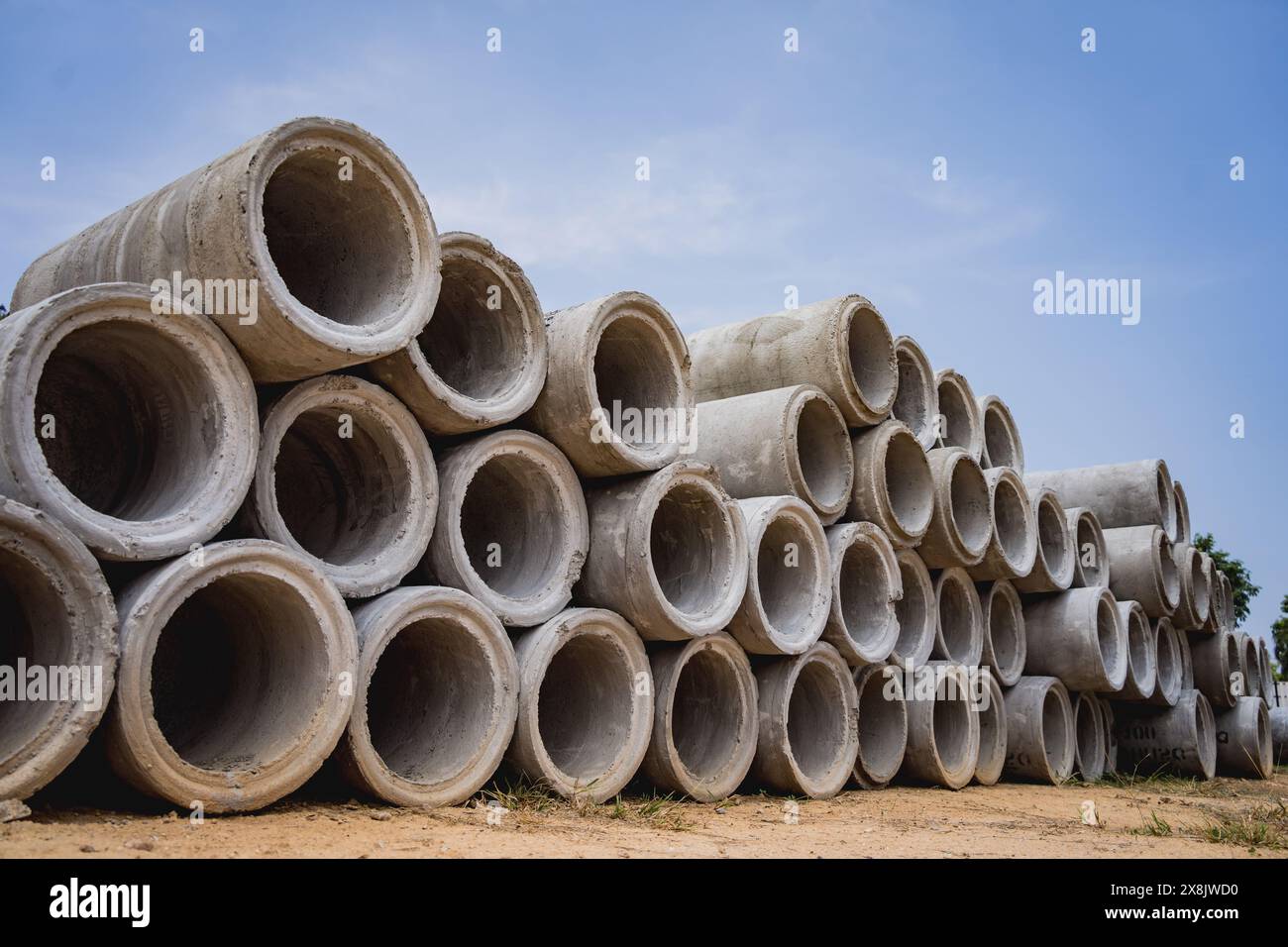 A stack of concrete ring pipes piled and creating a symmetrical ...