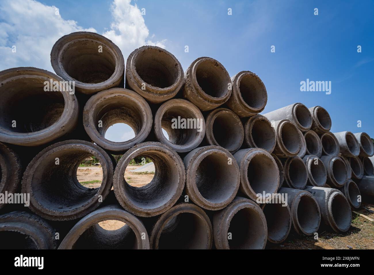 A stack of concrete ring pipes piled and creating a symmetrical ...