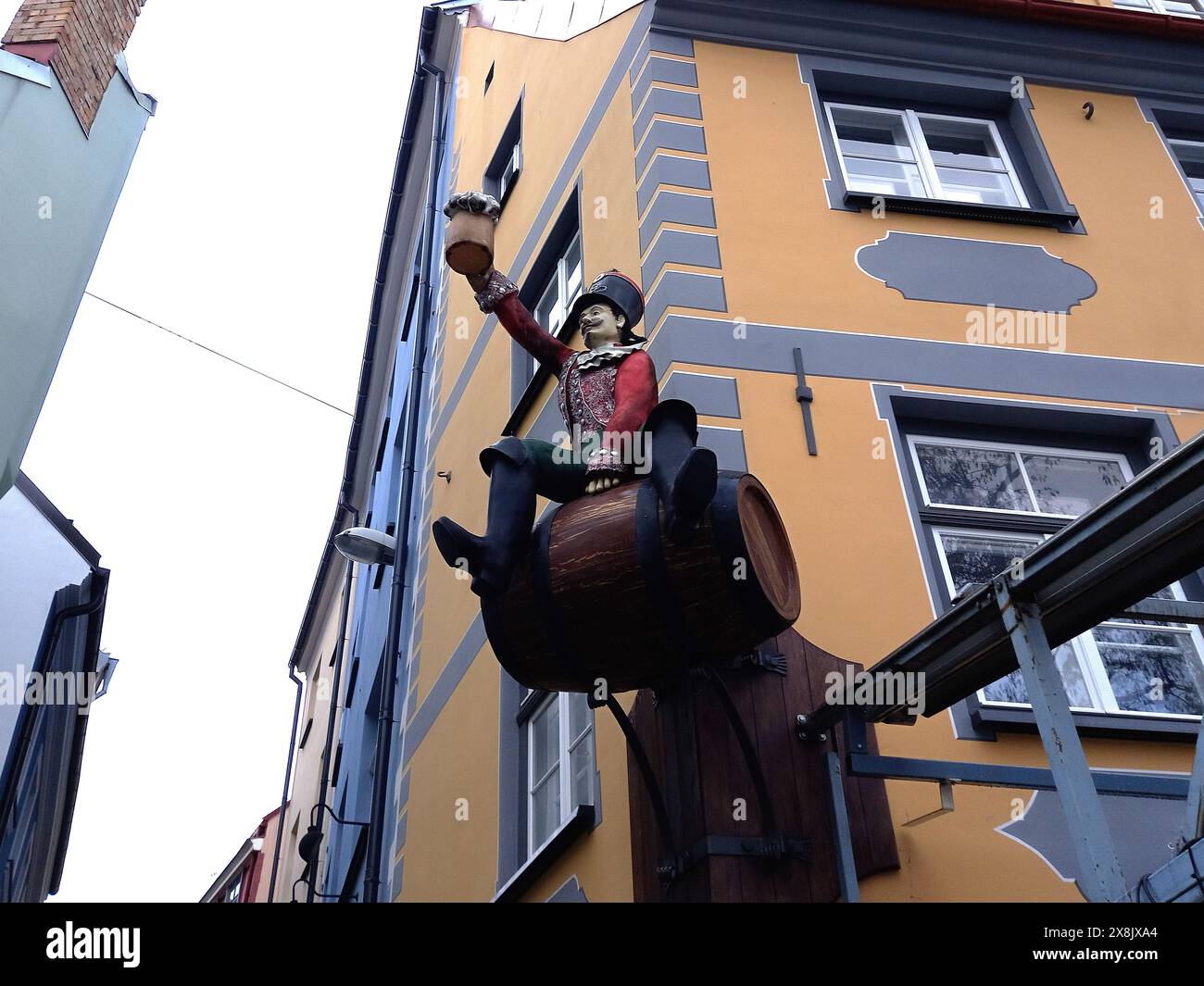 Pub bar baron Munchausen sitting on wine beer barrel downtown with ...
