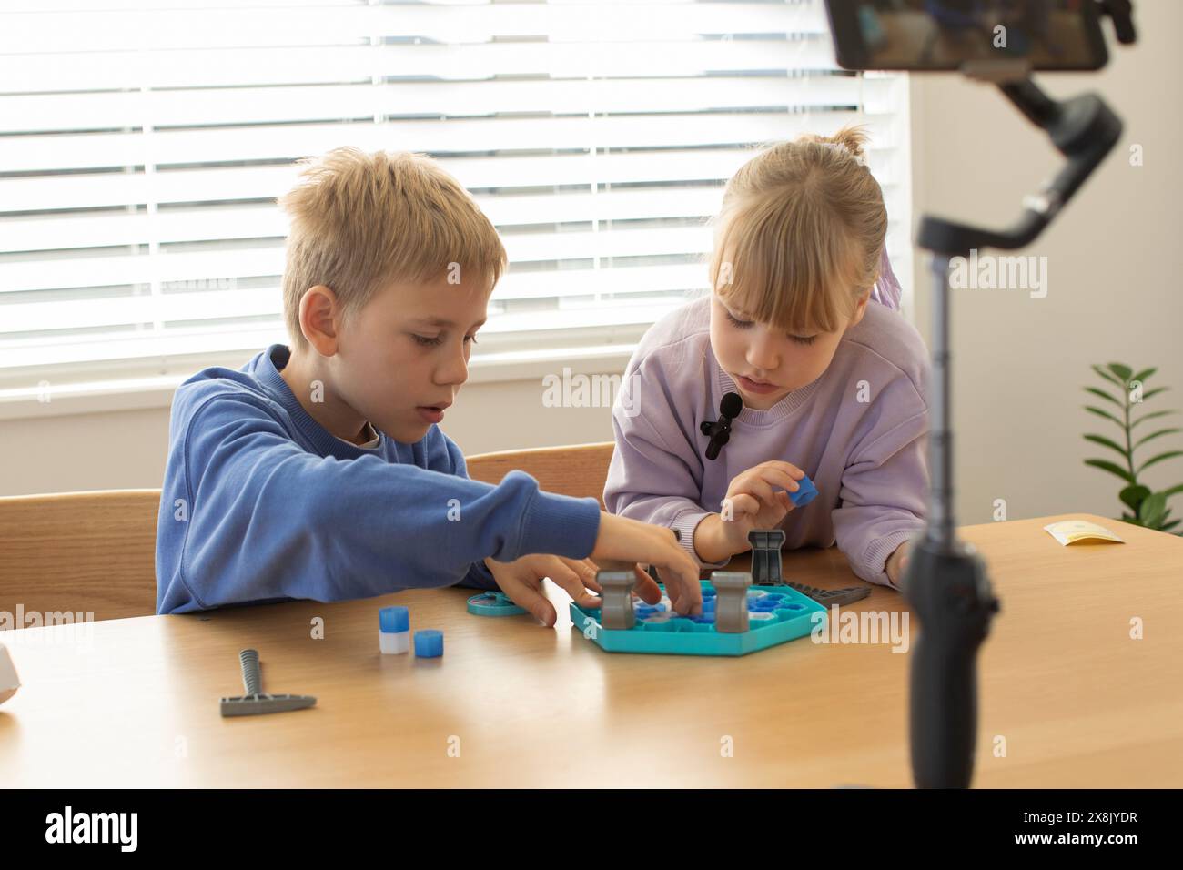 Kids play a new board game for their blog, recording a fun and ...