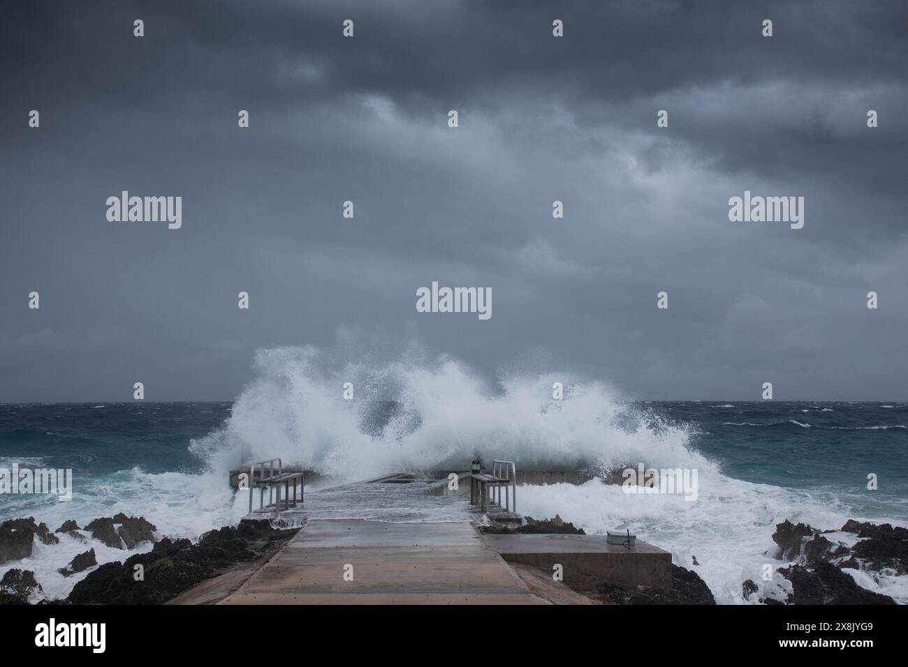 A raging ocean pounds a dock caused by tropical storm bad weather ...