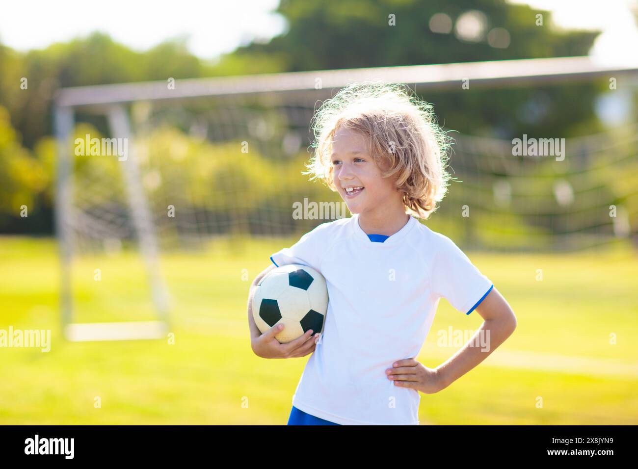 Kids play football on outdoor field. England team fan. Children score a ...