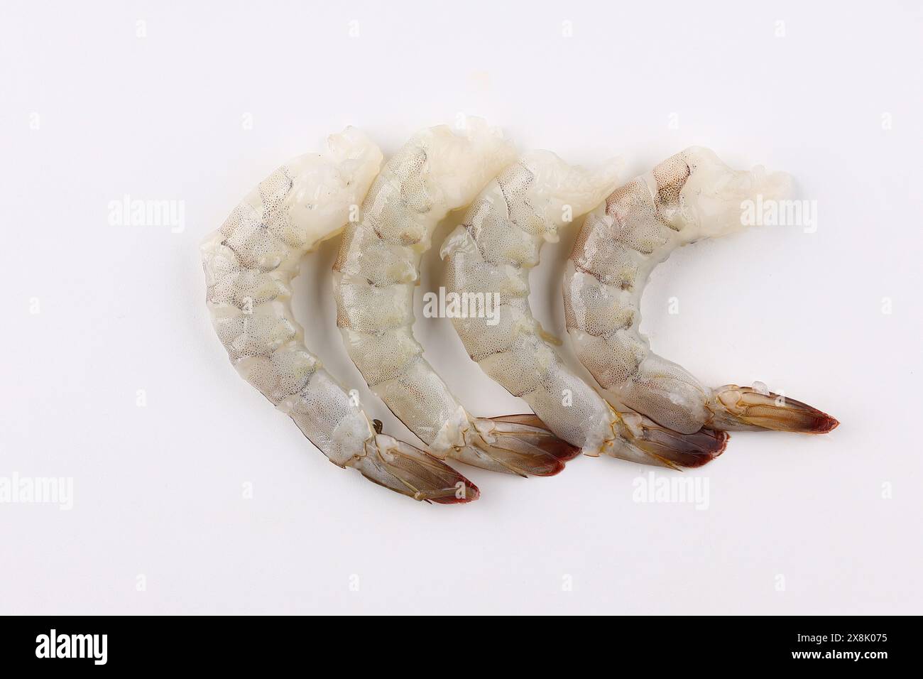 Seafood. Raw green royal prawns shrimp in a white plate with rosemary ...