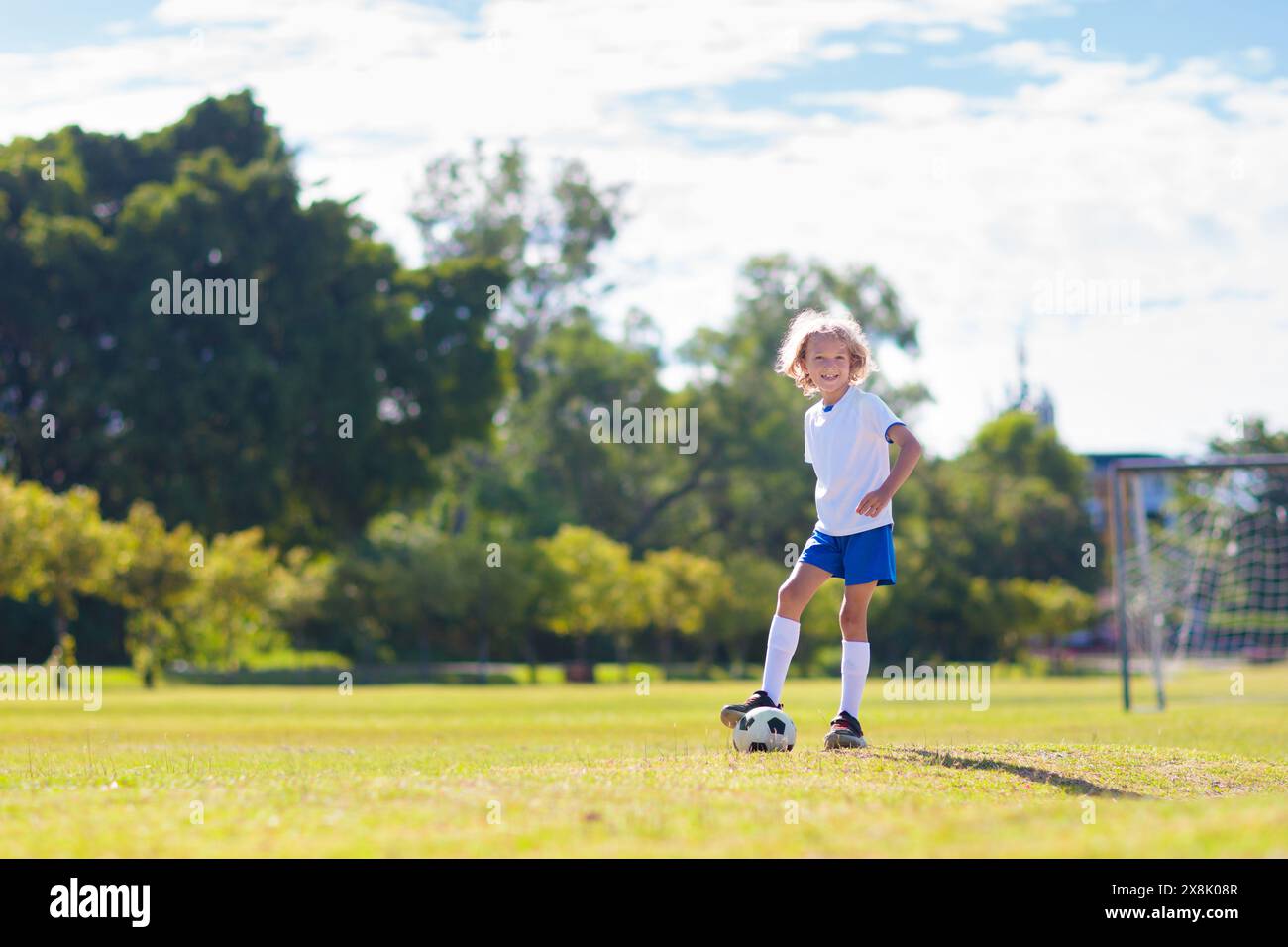 Kids play football on outdoor field. England team fan. Children score a ...
