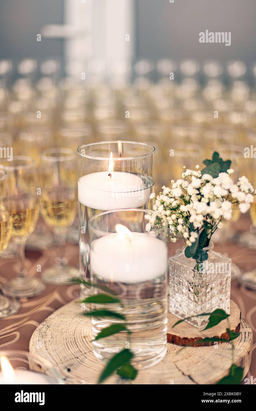 Warm candlelight setting for a festive event with delicate floral ...