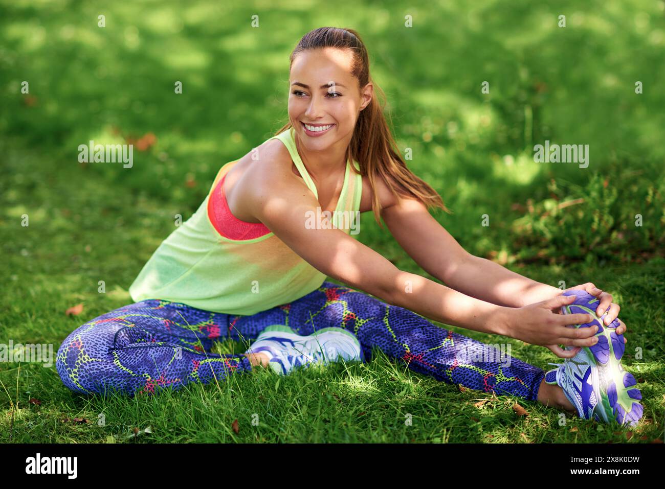 Outdoor, sportswear and smile of woman, stretching and workout in grass ...