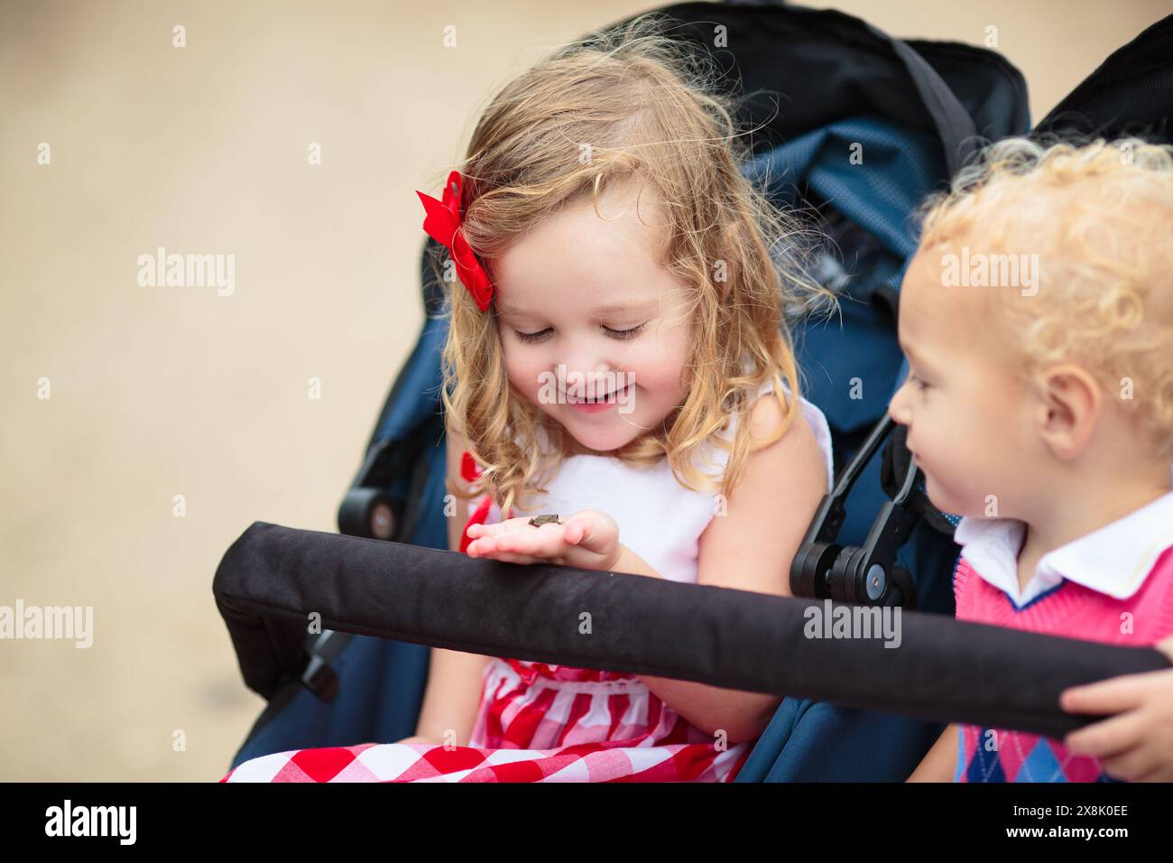 Kids catch a frog. Boy and girl looking at toad. Children and wild ...