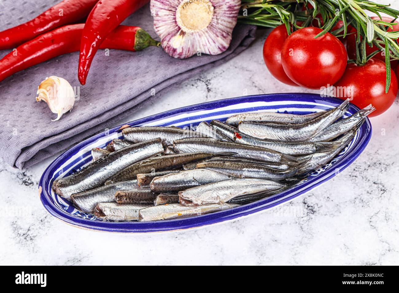 Pickled anchovy fish in the plate Stock Photo - Alamy