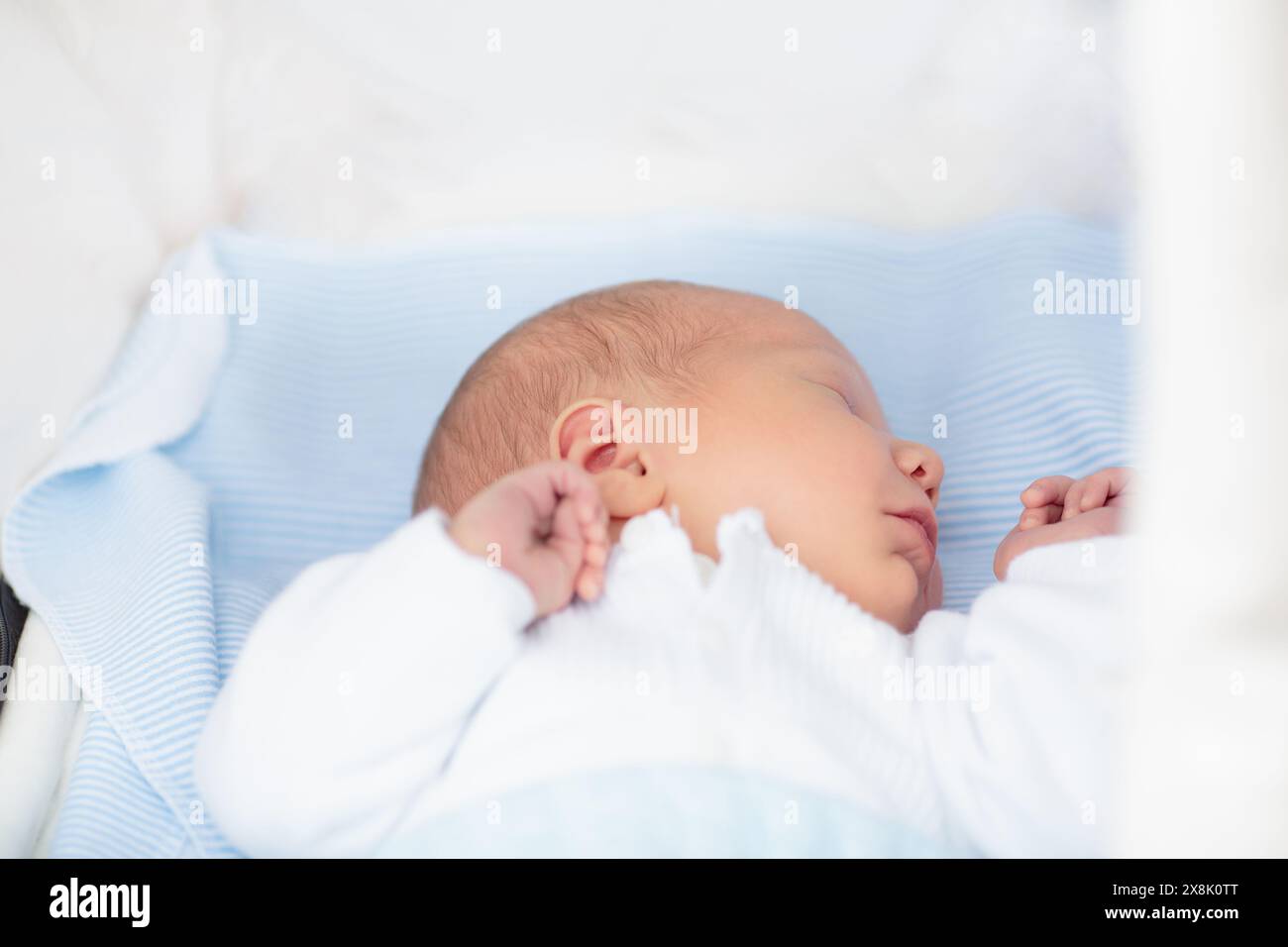 Newborn baby sleeping in white stroller on a walk in summer park. New ...