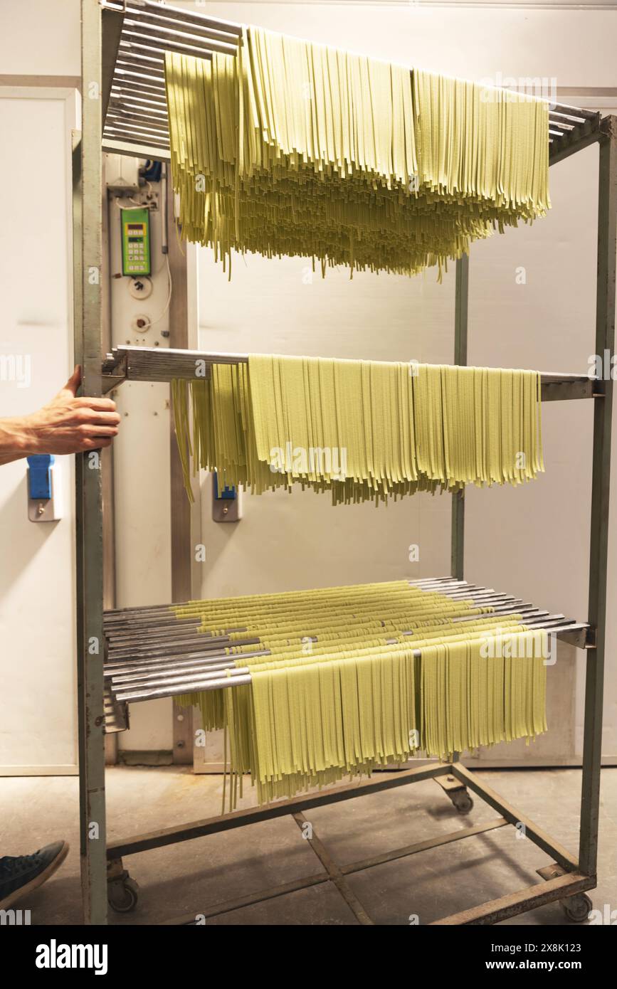 Fresh pasta drying on racks in kitchen Stock Photo - Alamy