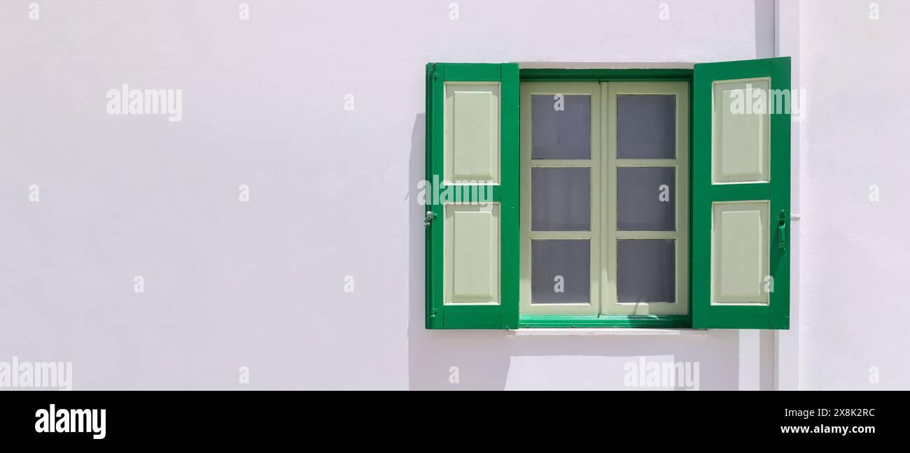 typical greek architecture, house with white exterior wall, window with ...