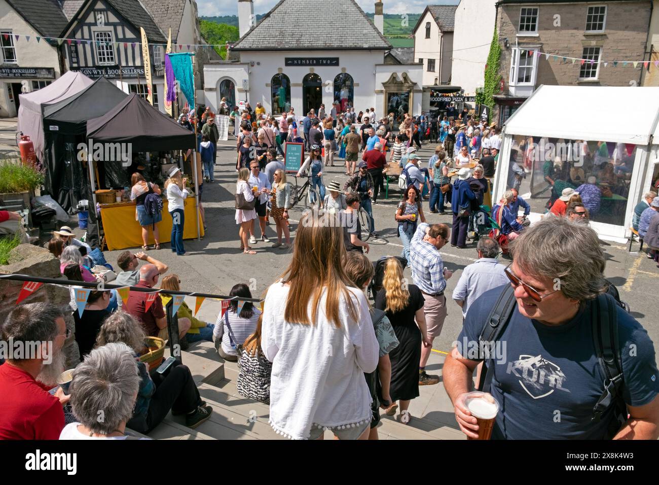 People visitors in Hay-on-Wye book town centre on a sunny day during ...