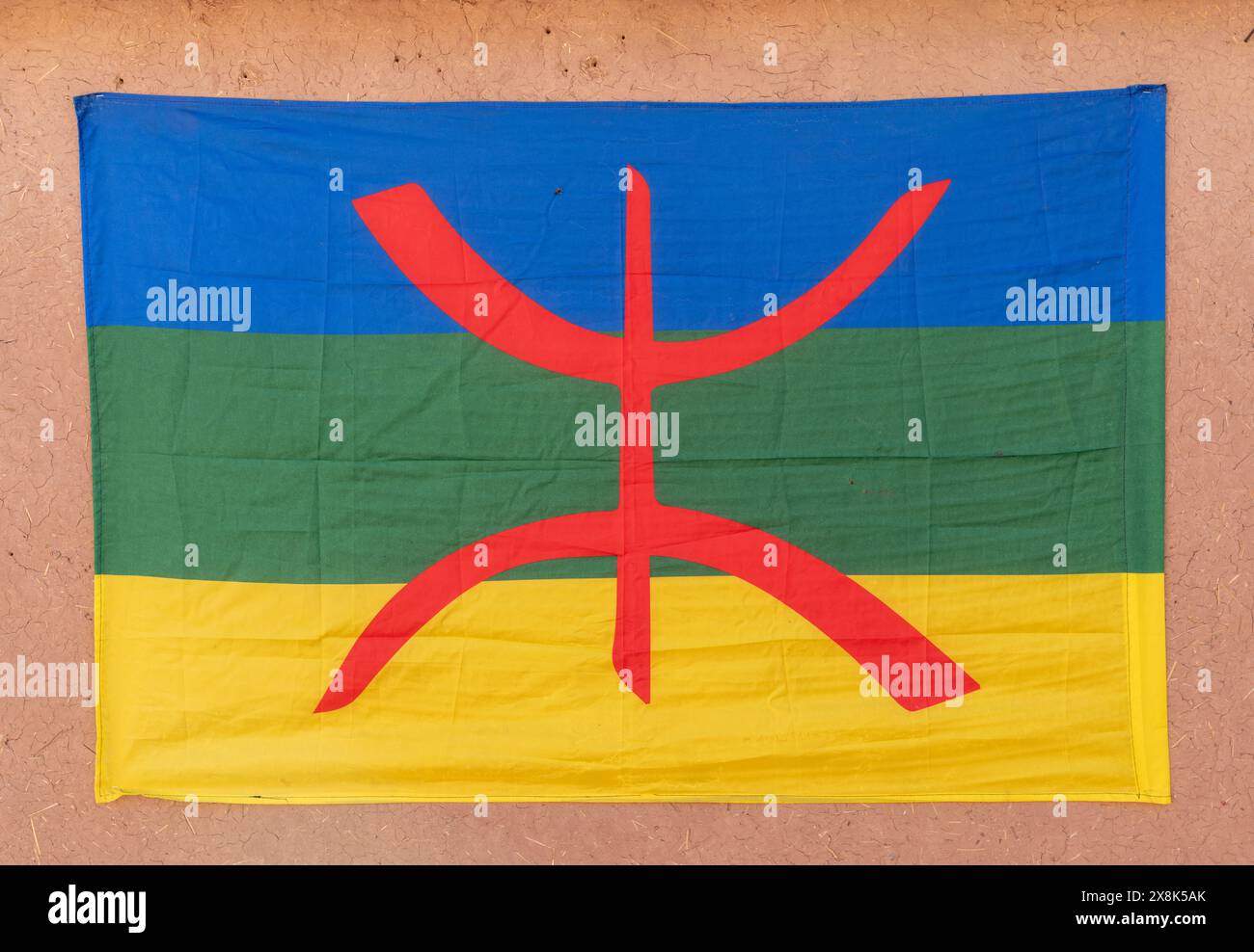 A close-up view of a Berber flag with the free man symbol hanging from ...