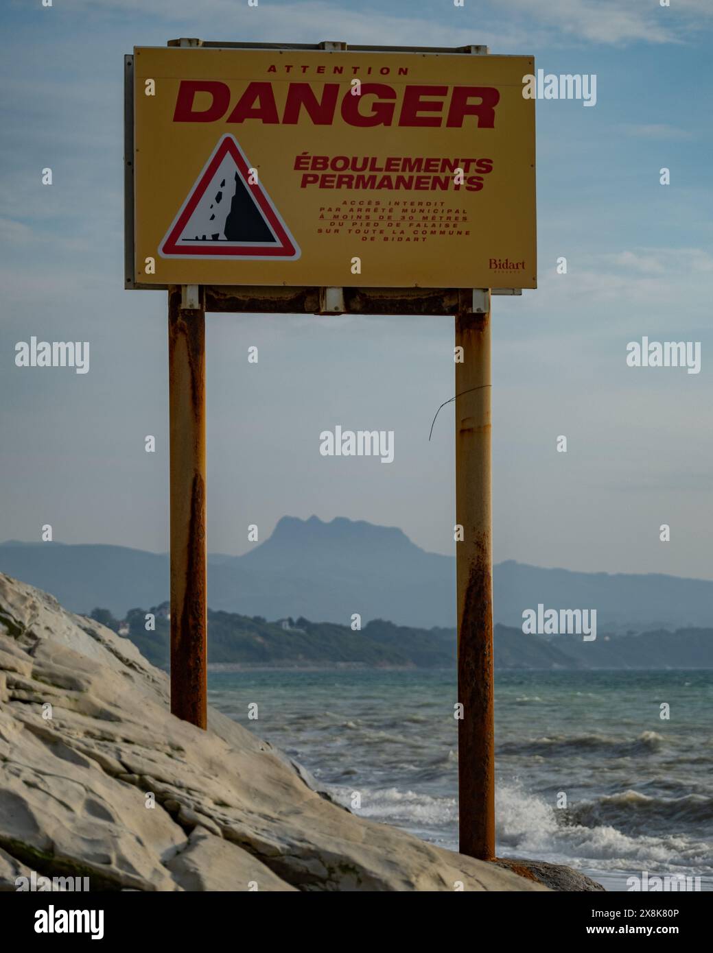 composition of a danger sign for landslides framing a mountain with ...