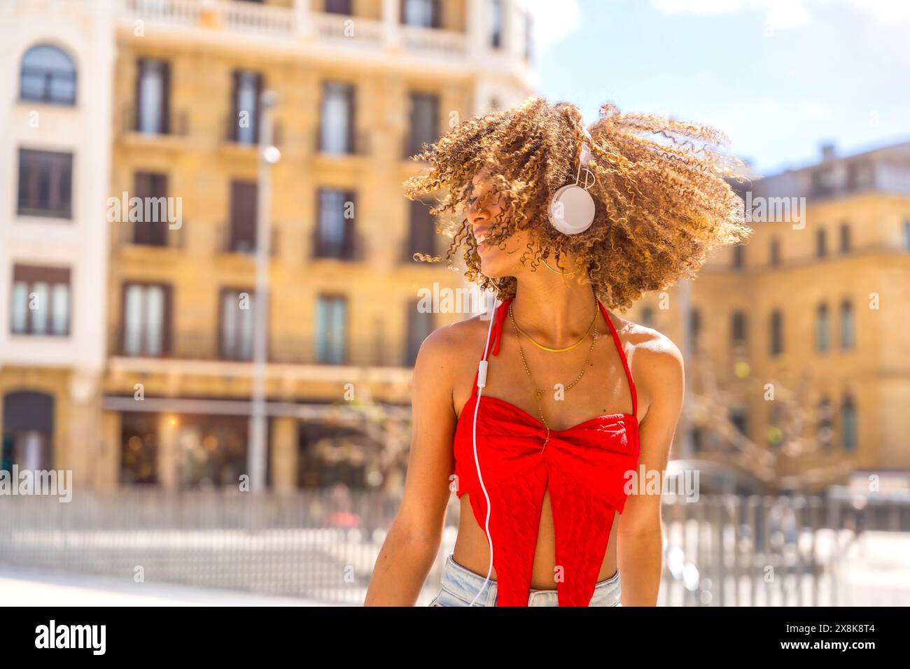 Latin beauty young woman with curly hair dancing listening to music ...