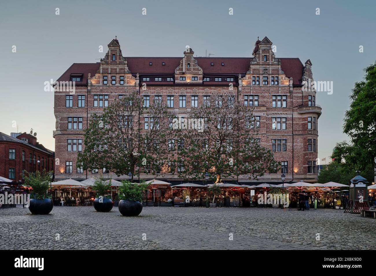the Little Square in Malmo with restaurants in a soft evening light ...