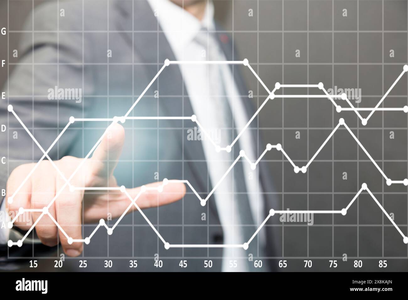 A businessman in a suit touches a virtual chart on a digital screen ...