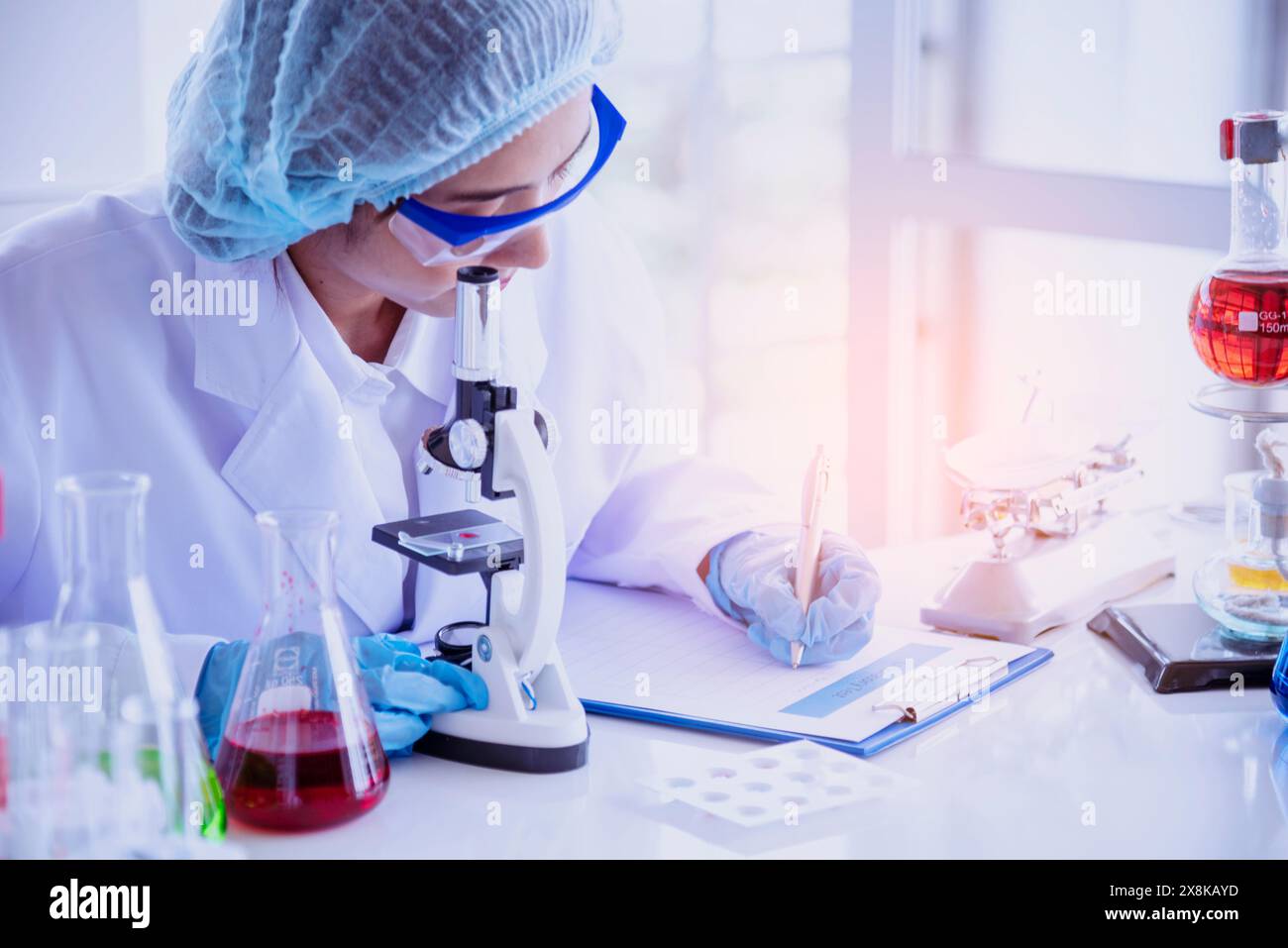 Female scientist look at microscope, science test tube analyse ...