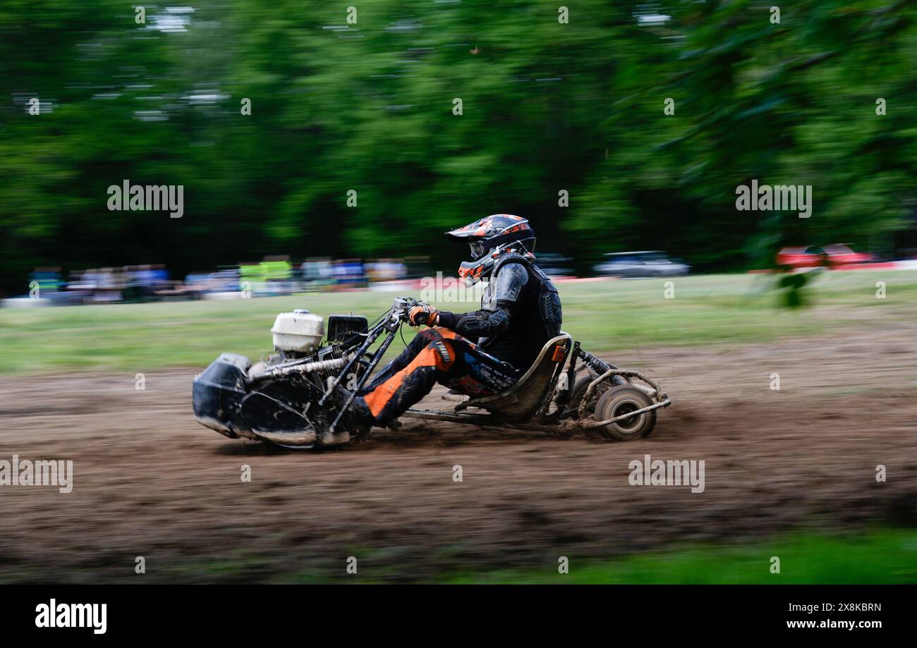 A competitor races in a heat during the World Lawnmower Championships ...