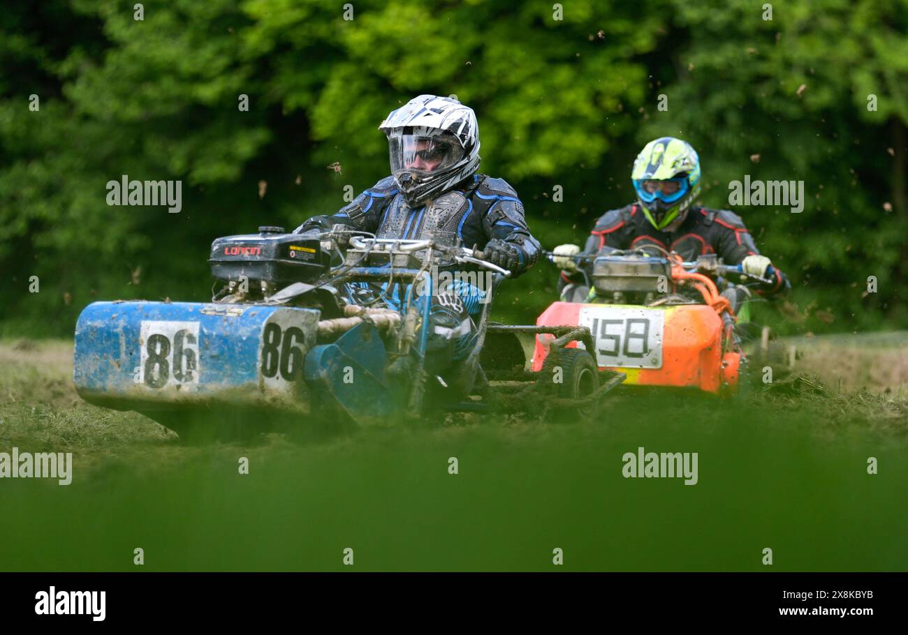 Competitors race in a heat during the World Lawnmower Championships ...