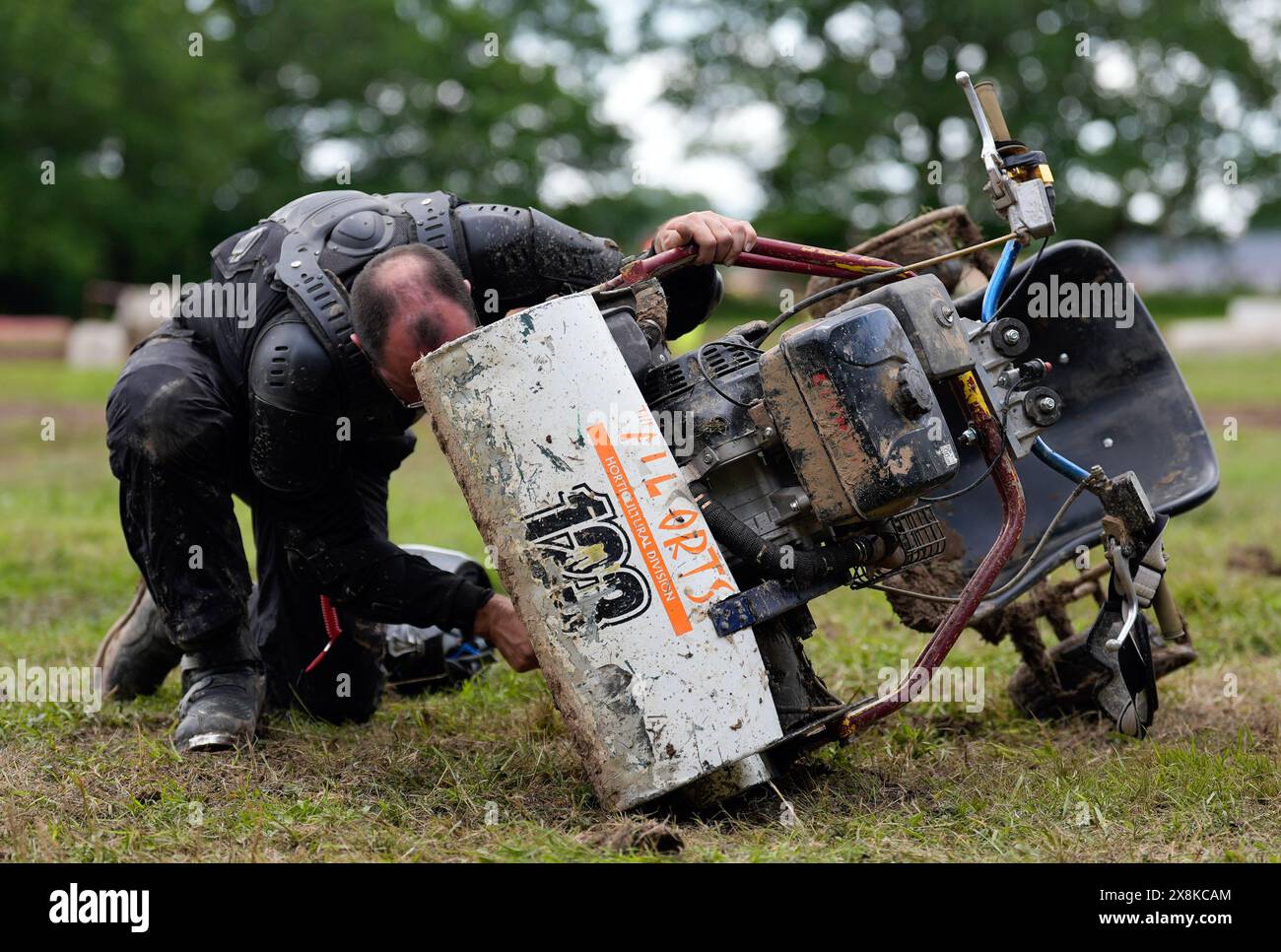 A competitor cleans their lawn mower between heats during the World ...