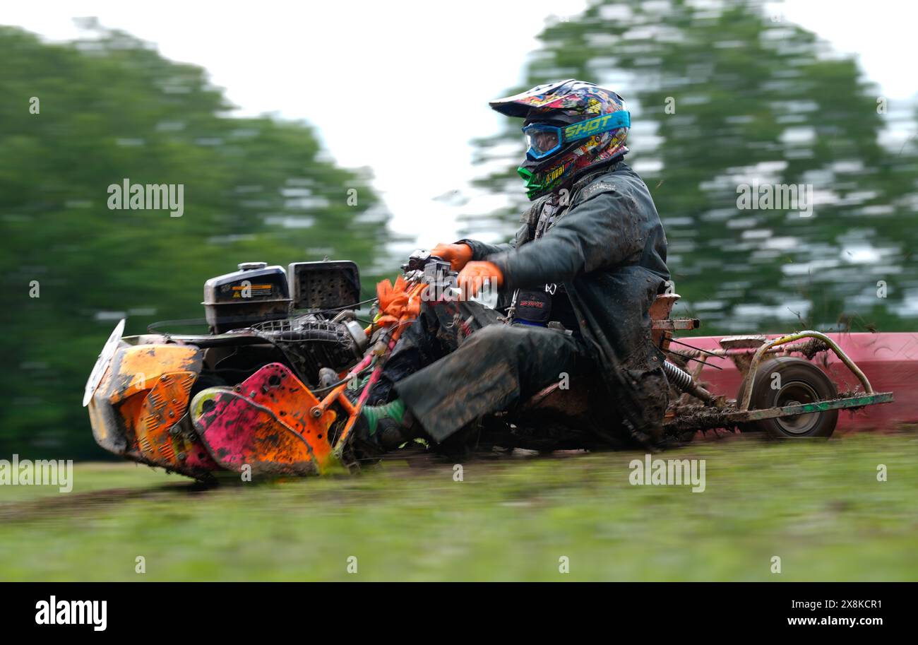 A competitor races in a heat during the World Lawnmower Championships ...