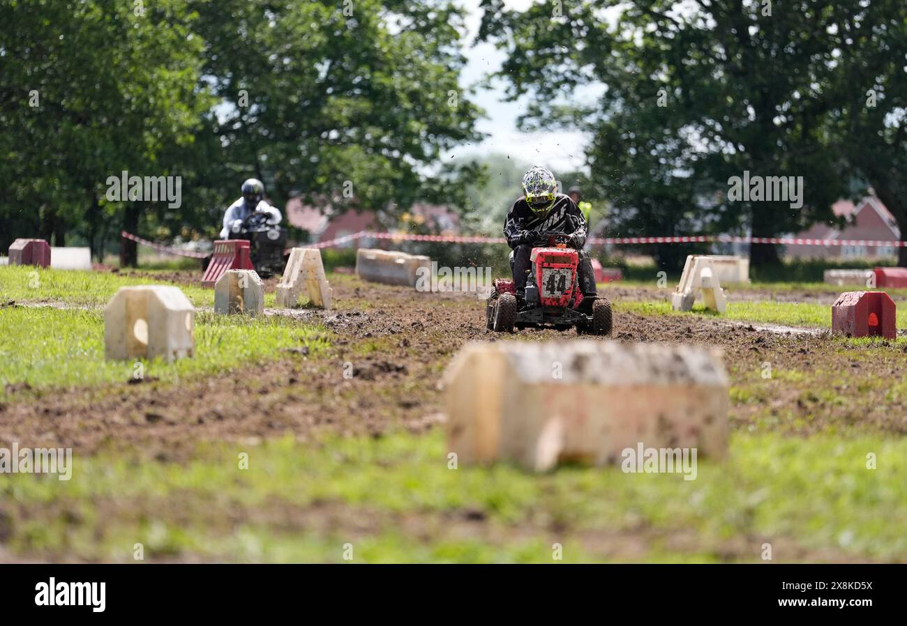 Competitors race in a heat during the World Lawnmower Championships ...