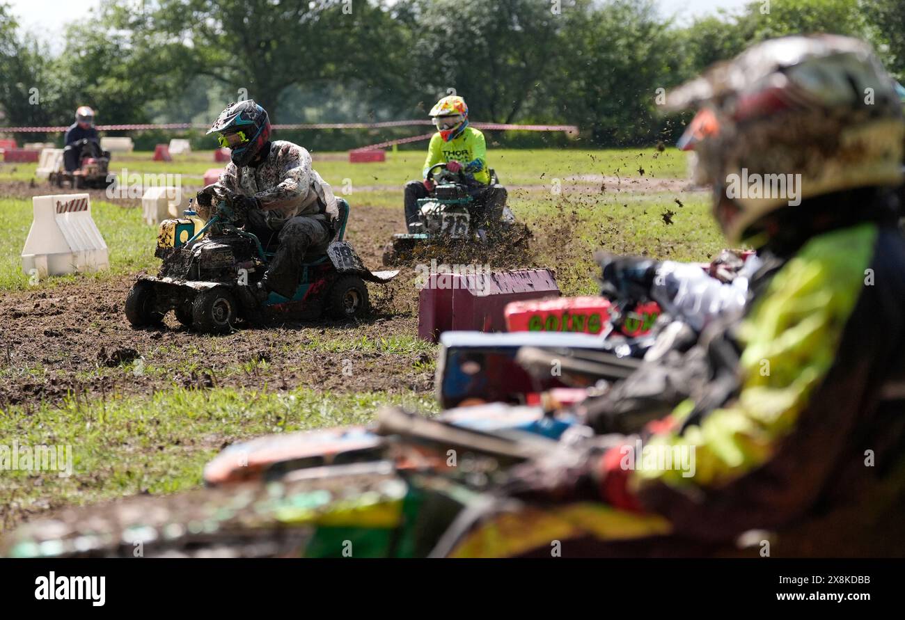 Competitors race in a heat during the World Lawnmower Championships ...