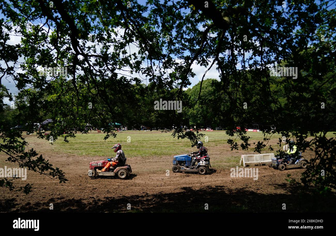 Competitors race in a heat during the World Lawnmower Championships ...