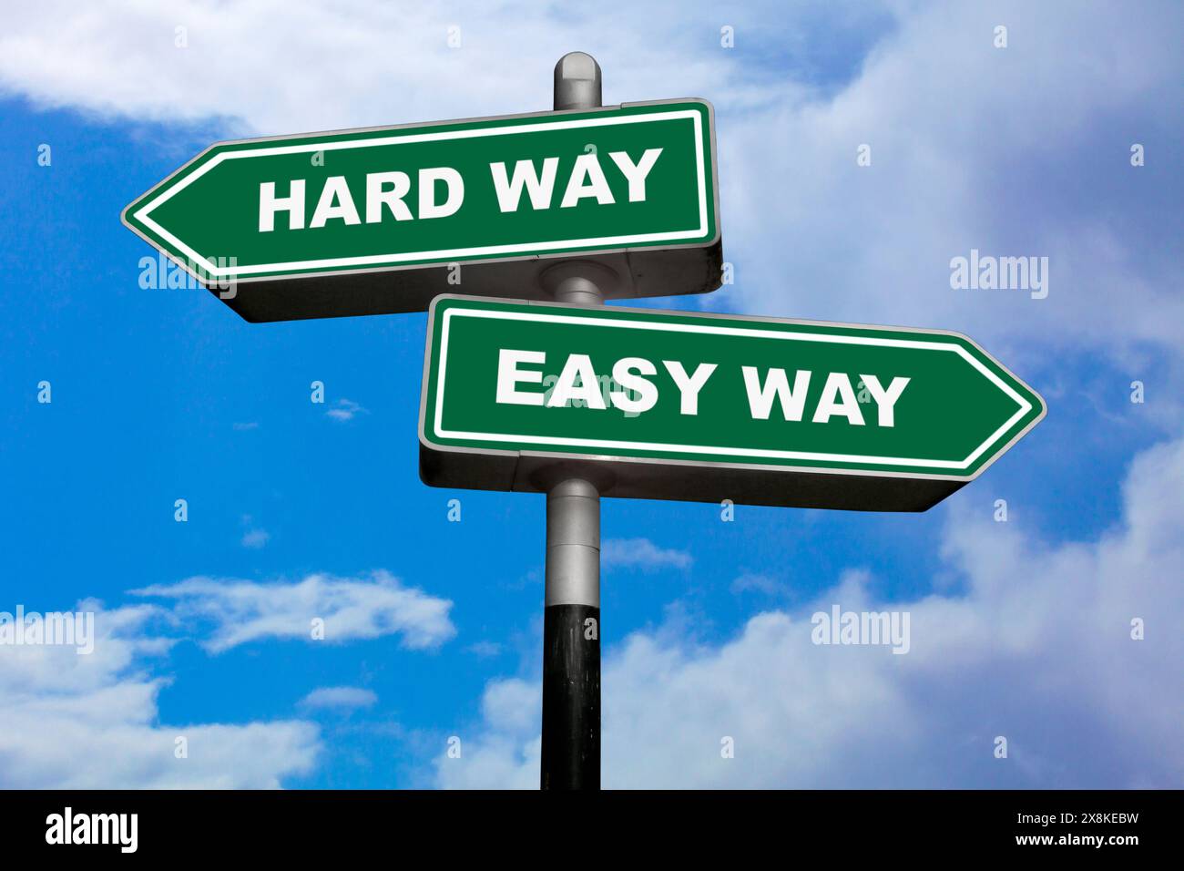 Two direction signs, one pointing left (Hard Way), and the other one ...