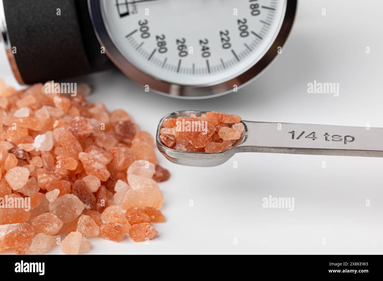 Sea salt with spoon and blood pressure monitor. High blood pressure ...
