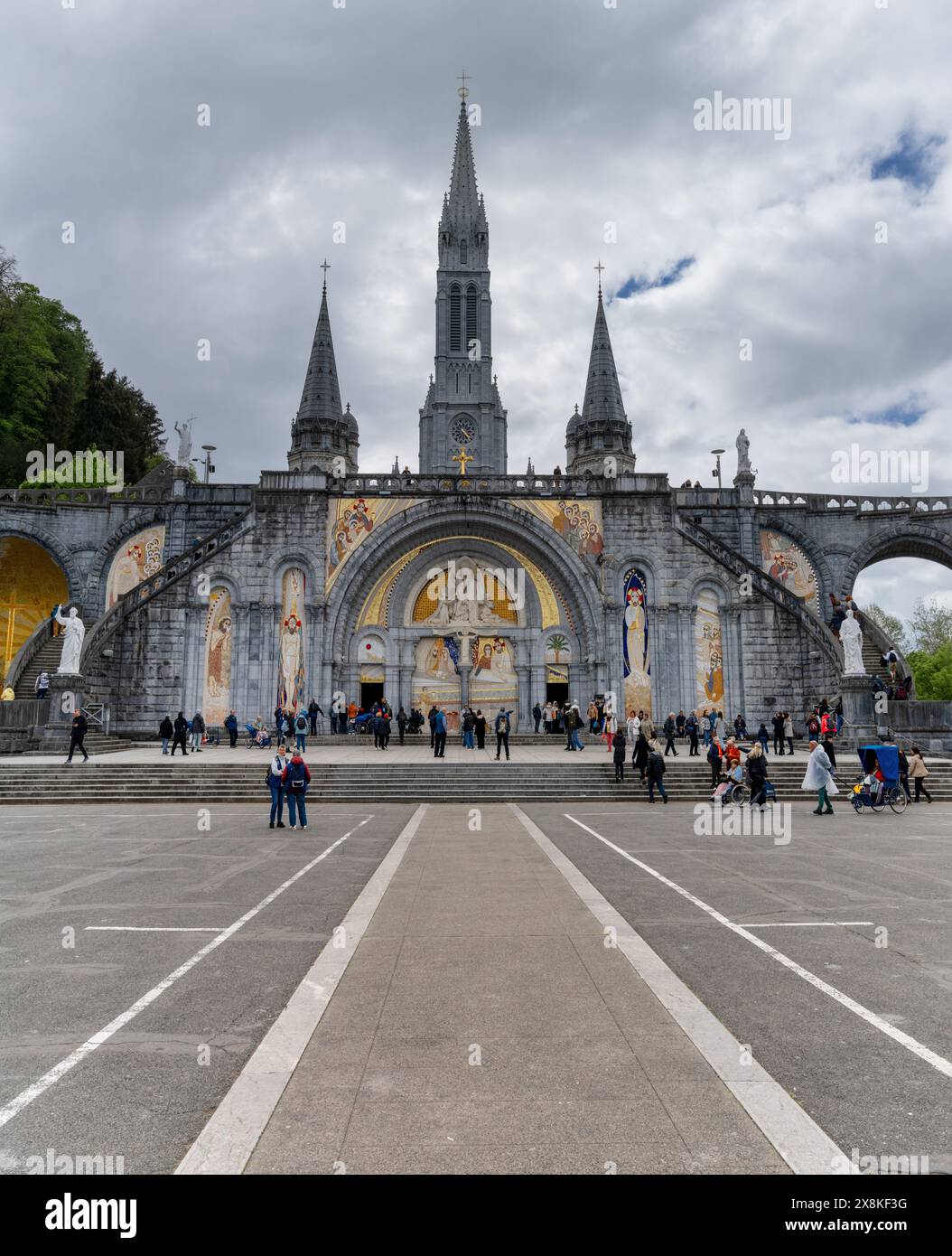 Lourdes, France - 17 April, 2024: many pilgrims visiting the Sanctuary ...