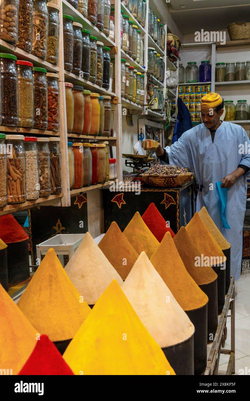 Marrakesh, Morocco - 24 March, 2024: shopkeeper preparing exotic spices ...