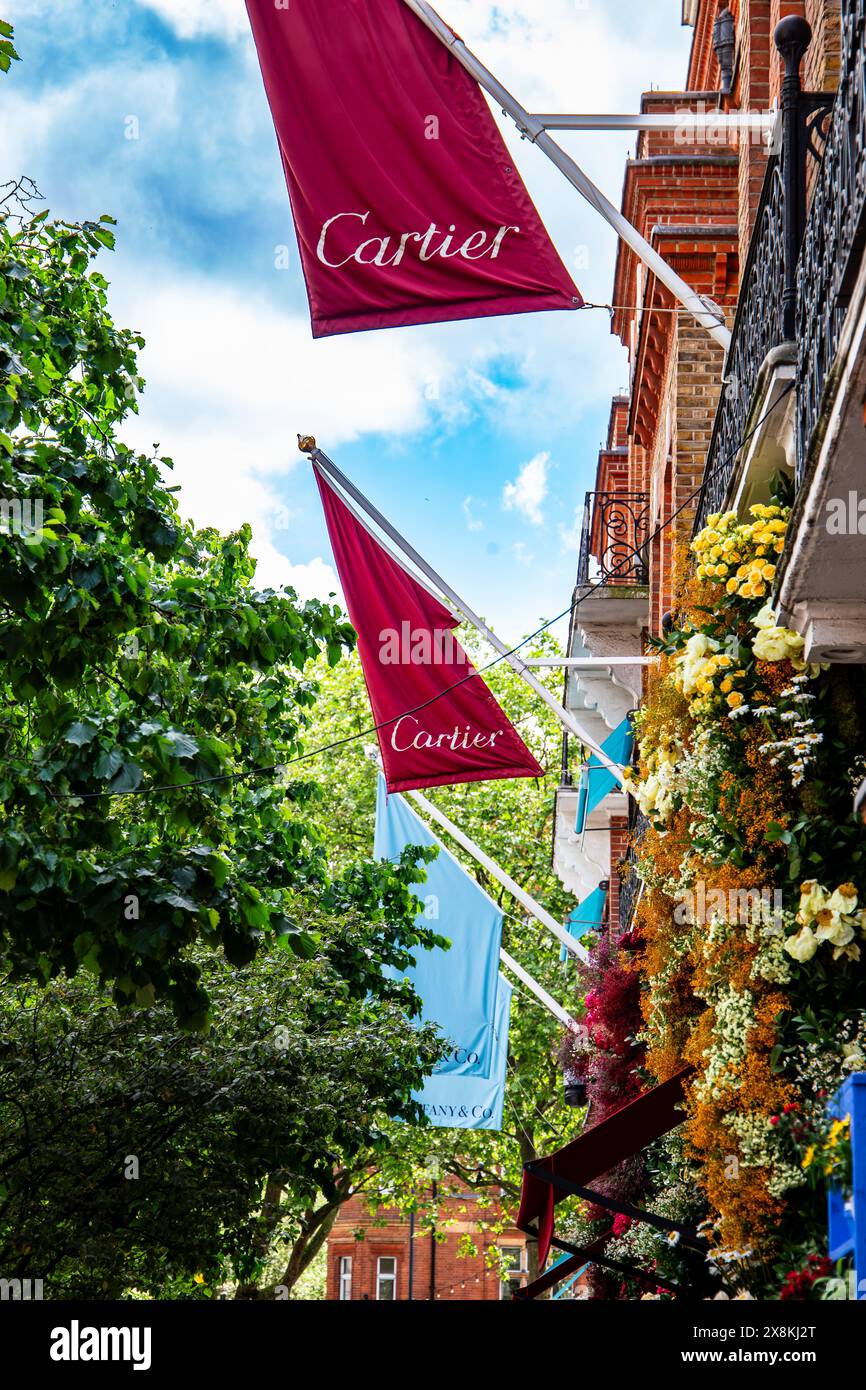 Cartier-branded flags fluttering above a flower-adorned luxury shopping ...
