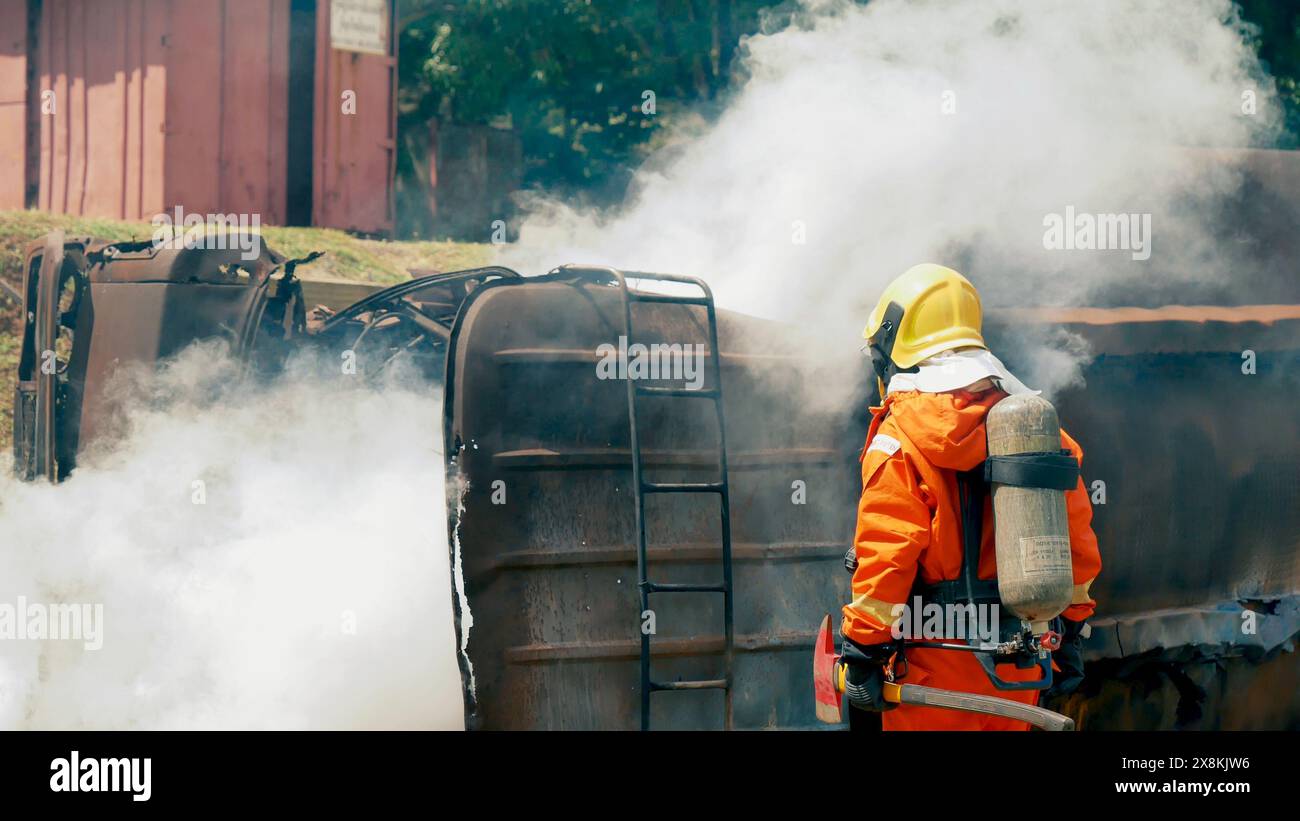 Firefighter fighting with flame using fire hose chemical water foam ...
