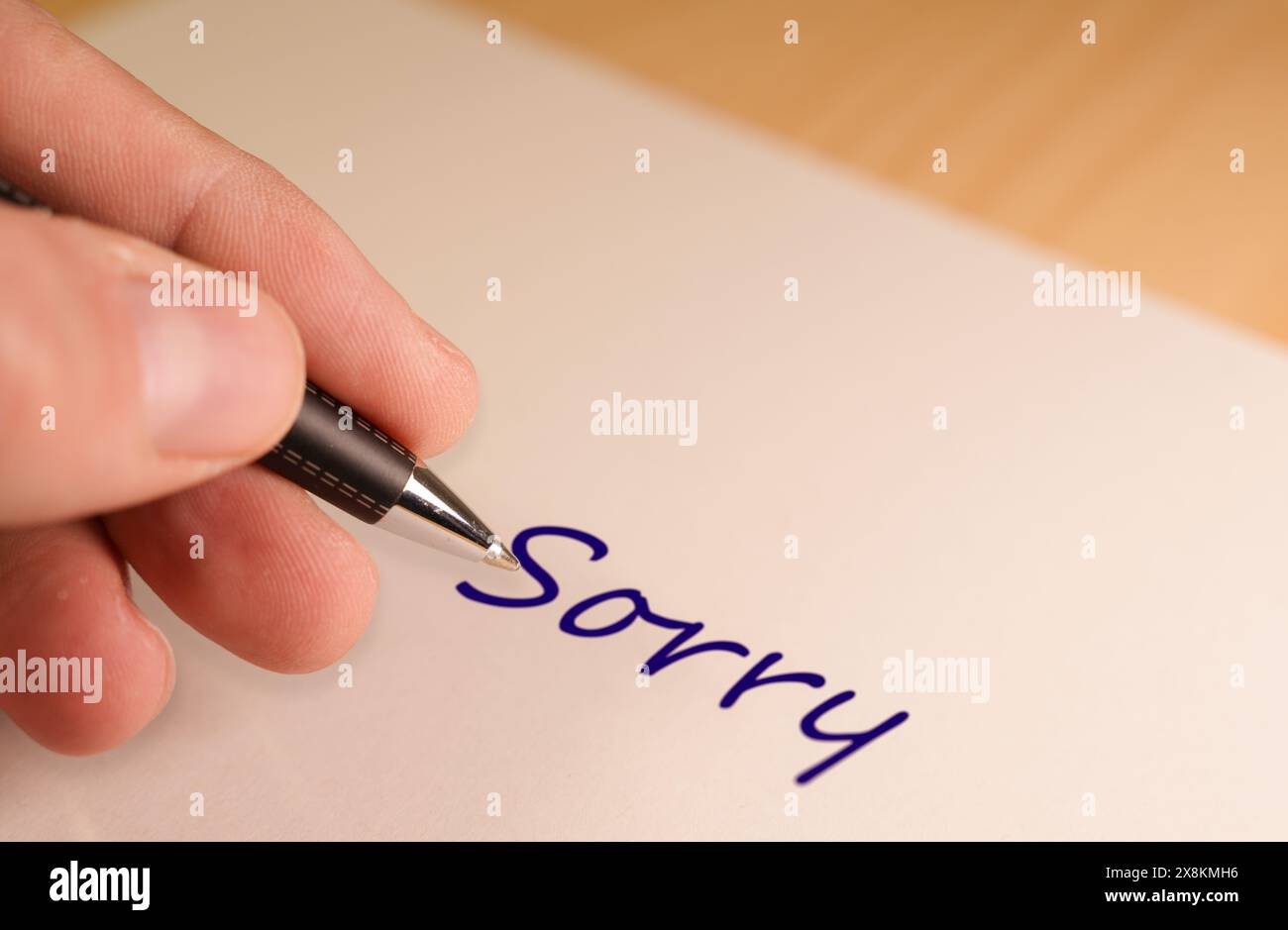 Close-Up of Hand Writing Sorry with Pen on Paper Stock Photo - Alamy