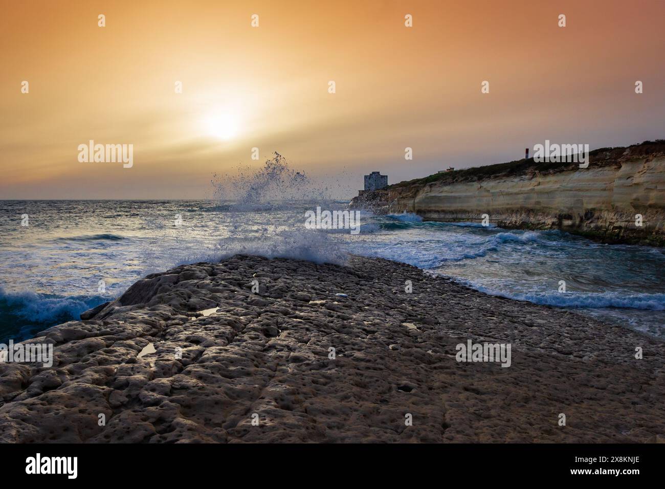 The sun rises over the horizon, illuminating a stunning beach landscape ...