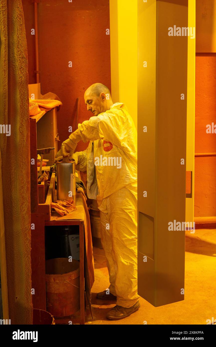 Perm, Russia - May 23, 2024: worker thins paint with solvent in ...