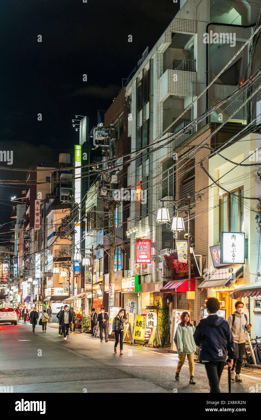 Evening view along street packed with restaurants, diners and clubs ...