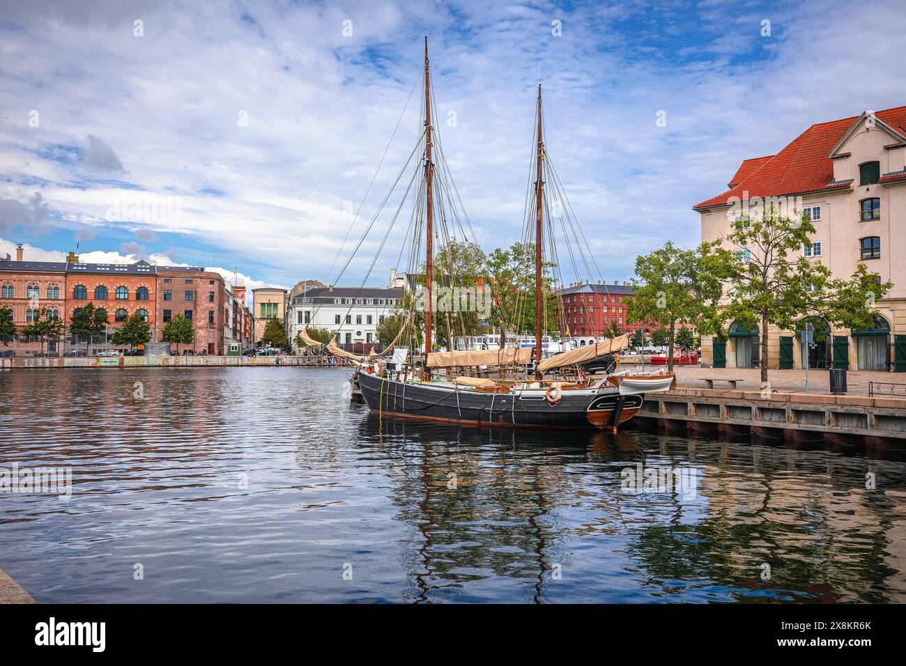 Scenic waterfront and wooden sailboat in Copenhagen waterfront view ...