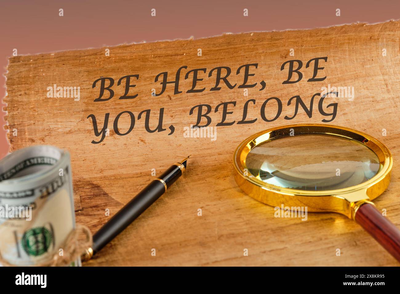 BE HERE, BE YOU, BELONG Words written on papyrus next to a magnifying ...
