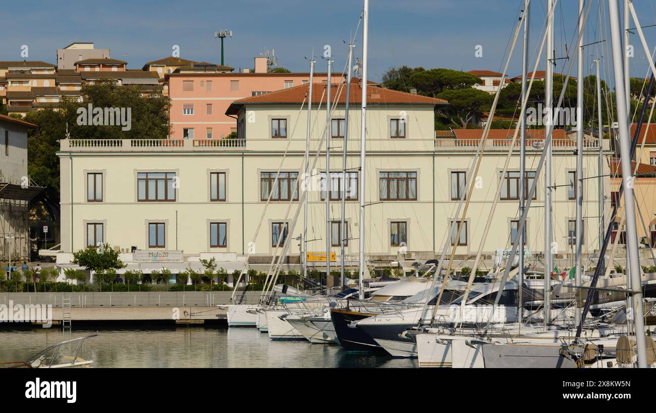 Town hall seen from the tourist port of San Vincenzo, with moored ...
