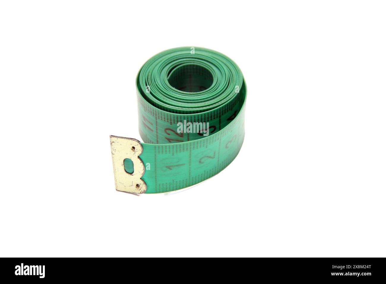 Twisted green measuring tape isolated on white Stock Photo - Alamy